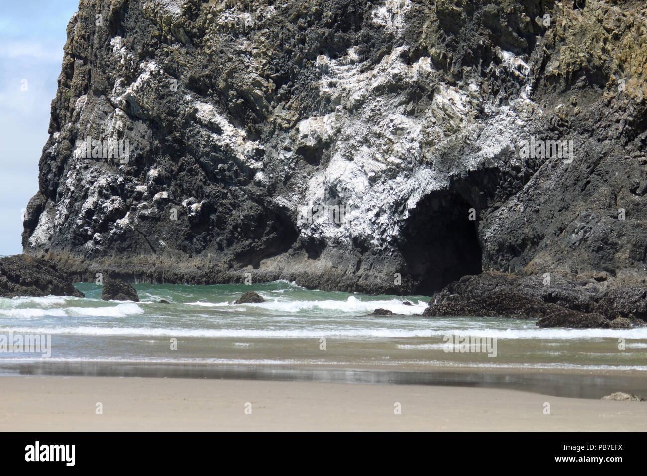 A small cave in the side of the cliff on the beach Stock Photo - Alamy