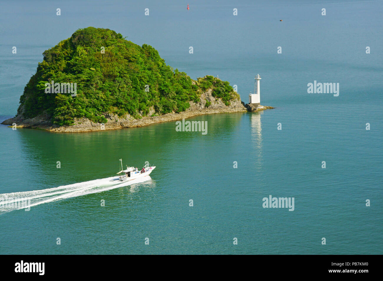 Lighthouse and Fishing Boat Stock Photo - Alamy