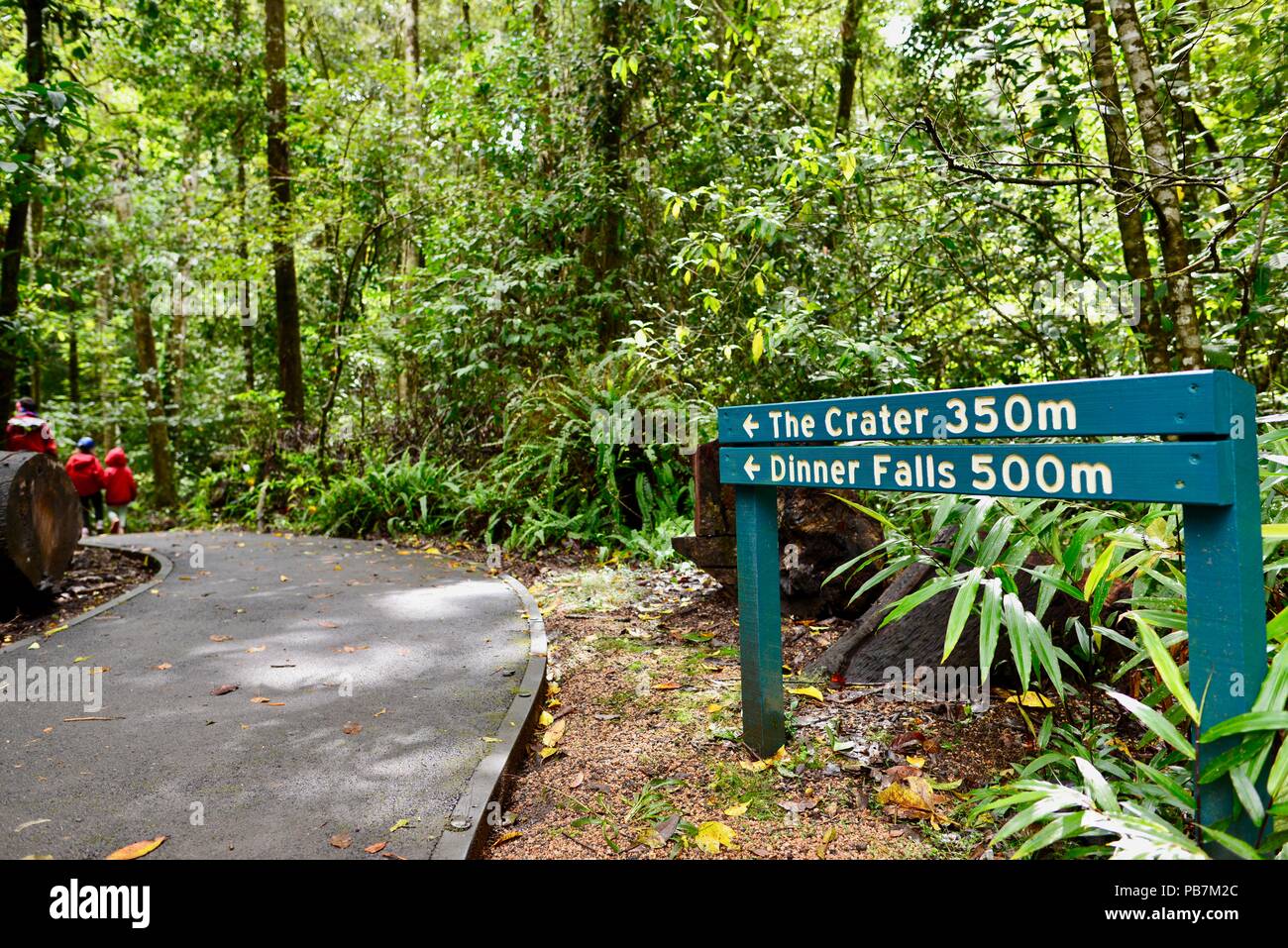 People walking past the dinner falls and crater direction sign hi-res ...
