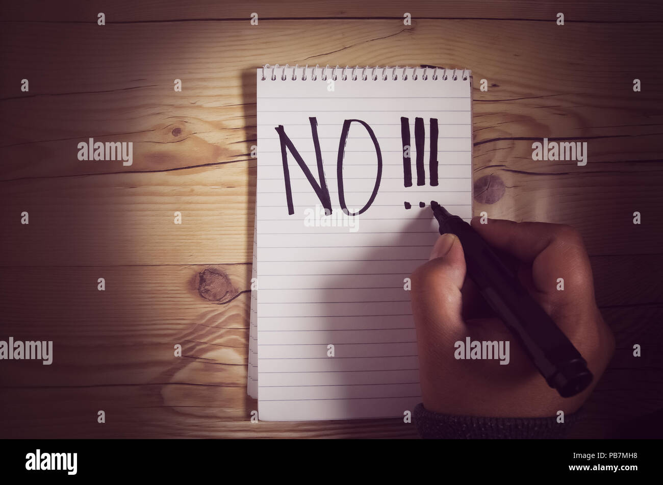 Human hand writing NO in a spiral notebook Stock Photo - Alamy