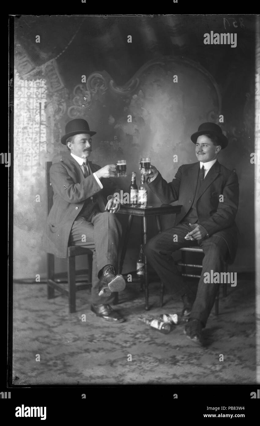 . English: Portrait of Two men drinking Louis Obert Gold Beer ...