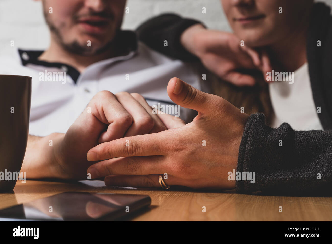 The man the hand caresses a female hand. Against the background of the ...