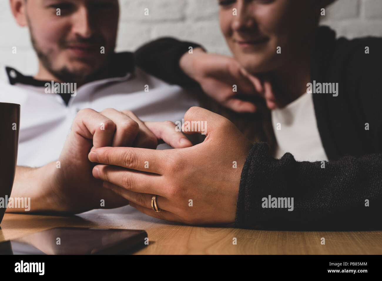 The man the hand caresses a female hand. Against the background of the ...