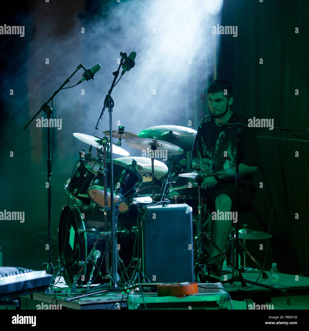 Drummer performing on a stage with lighting Stock Photo - Alamy