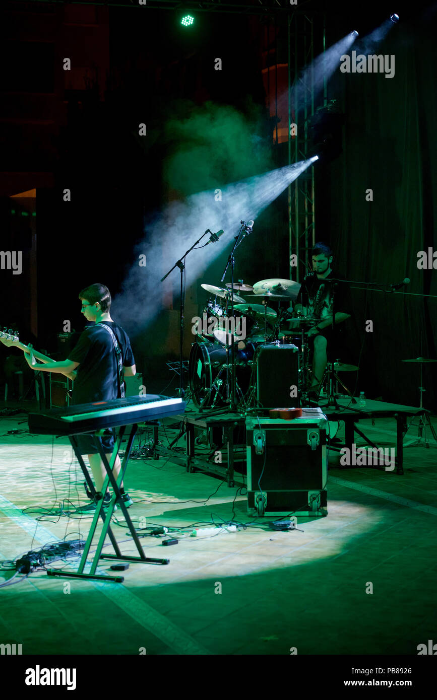 Drummer performing on a stage with lighting Stock Photo - Alamy