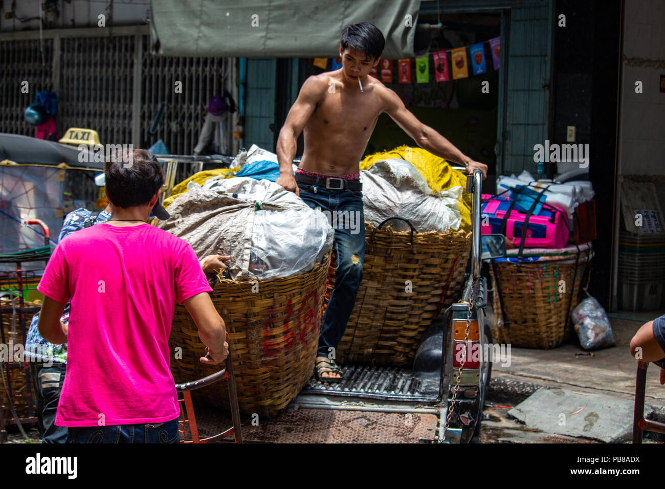 Bangkok, Thailand - May 1, 2018: Workers carrying heavy loads in a ...