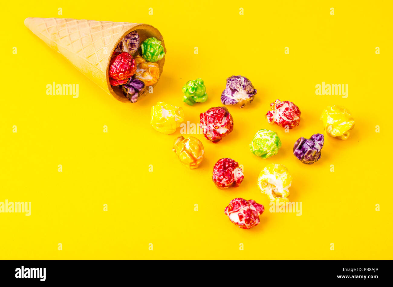 Sweet colored popcorn on bright background. Studio Photo Stock Photo ...