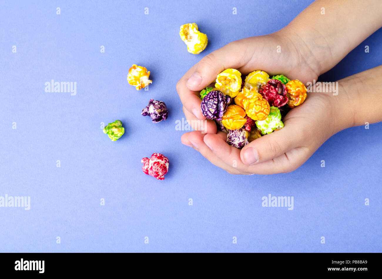 Colorful popcorn in children's hands. Studio Photo Stock Photo - Alamy