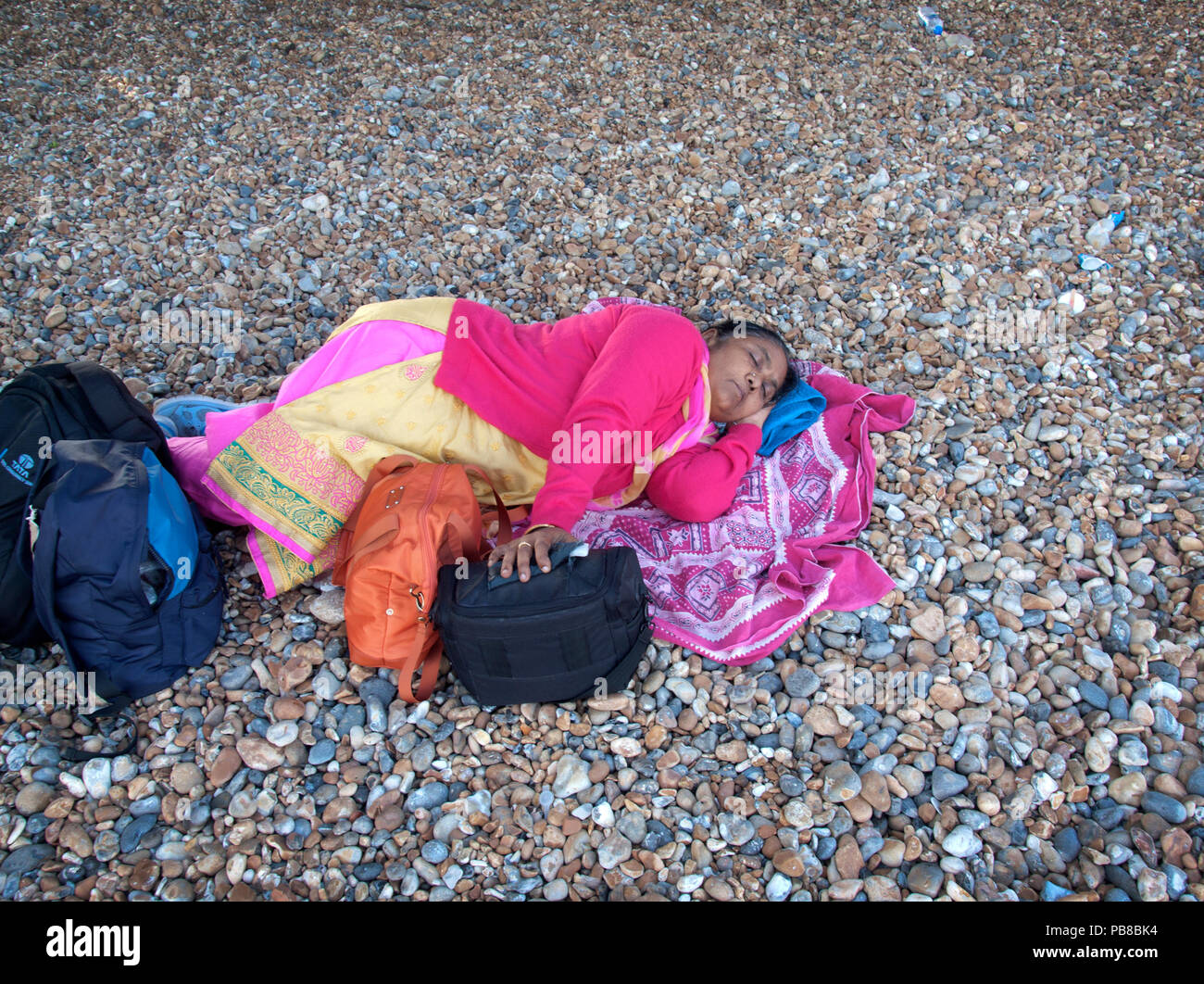 Woman asleep on beach hi-res stock photography and images - Alamy