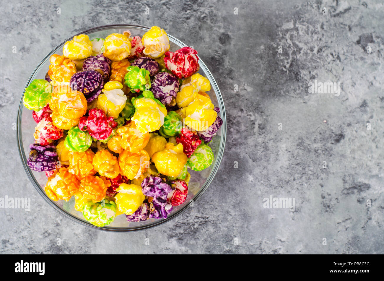 Sweet colored popcorn on bright background. Studio Photo Stock Photo ...