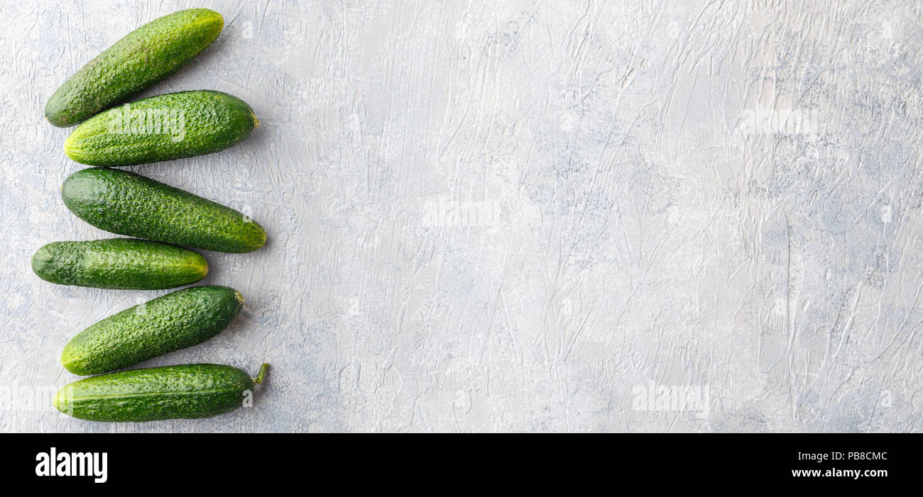 Fresh raw juicy cucumbers on a light background. Horizontal photo ...