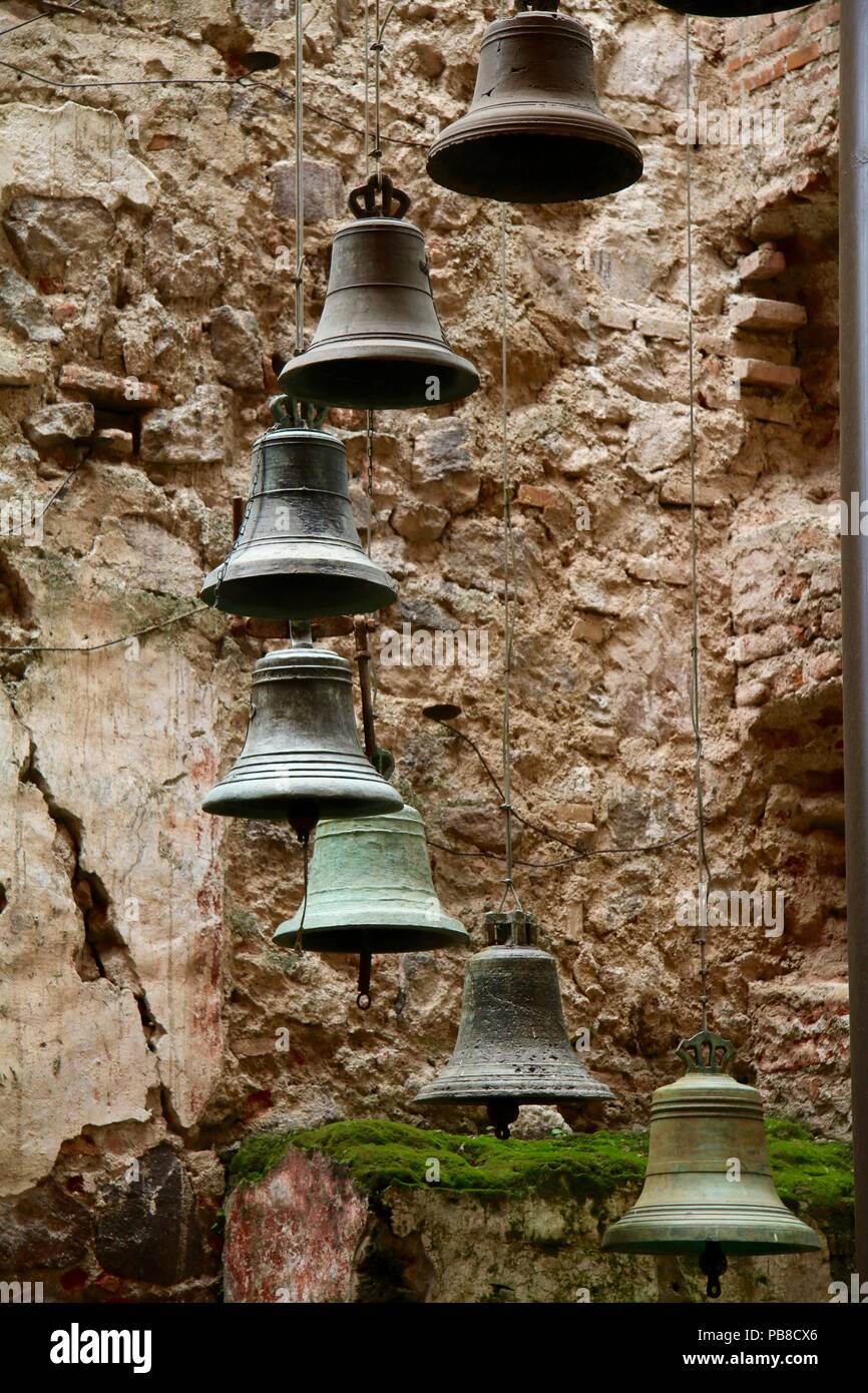 Hanging bells spiralling down with a rock wall backdrop Stock Photo - Alamy
