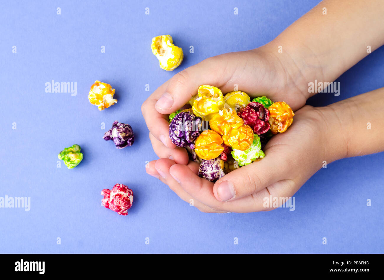Colorful popcorn in children's hands. Studio Photo Stock Photo - Alamy