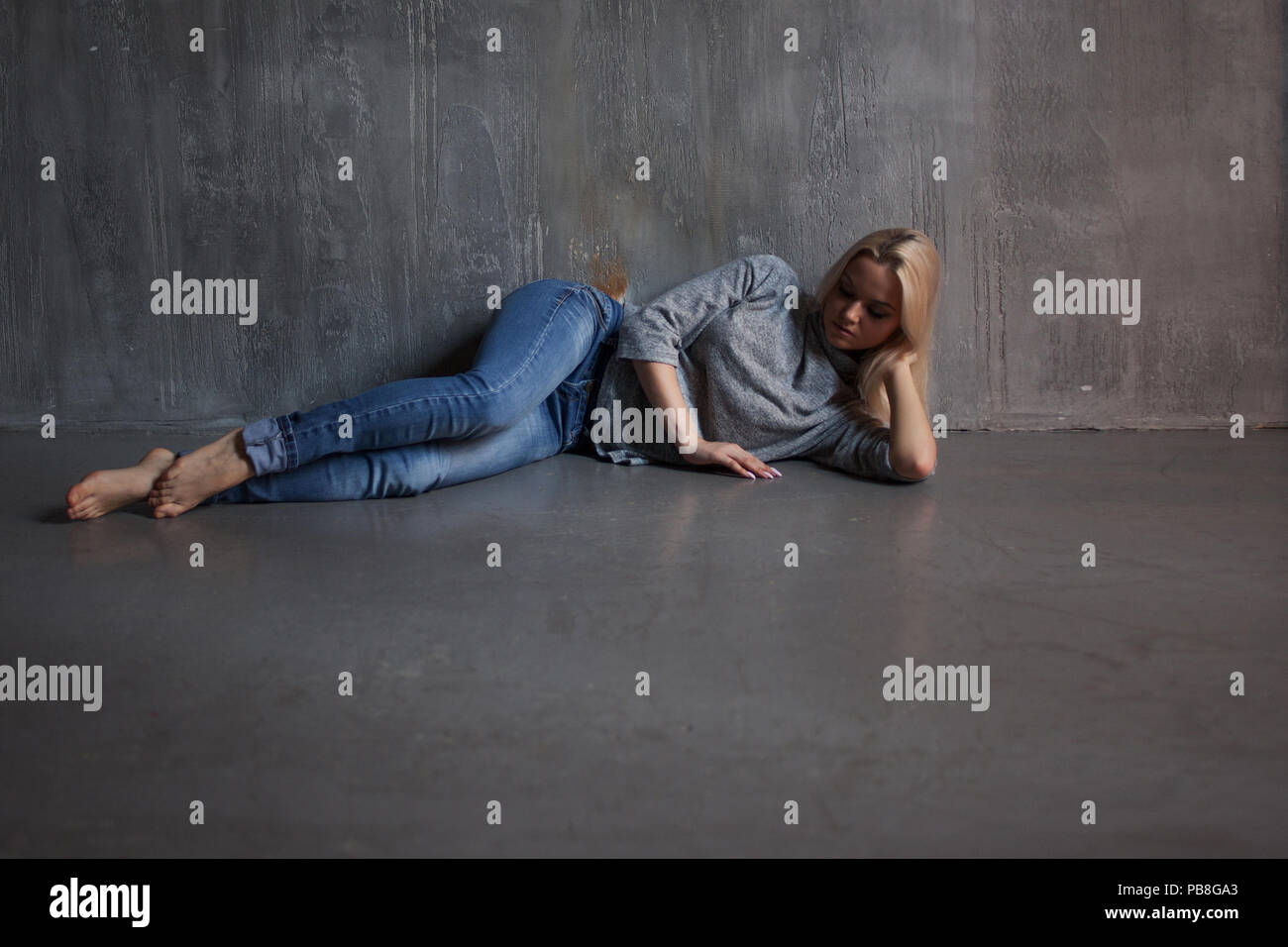 Depression. Young woman lying on the floor, concept of stress or post ...