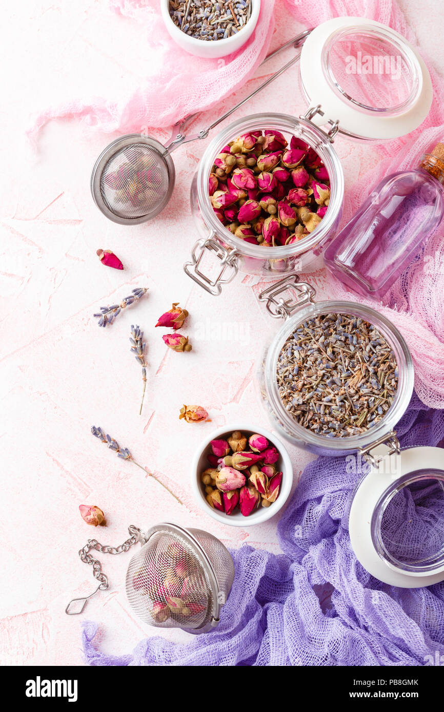 Dried rose flower buds and flowers in glass jars. Herbal tea, cleansing ...