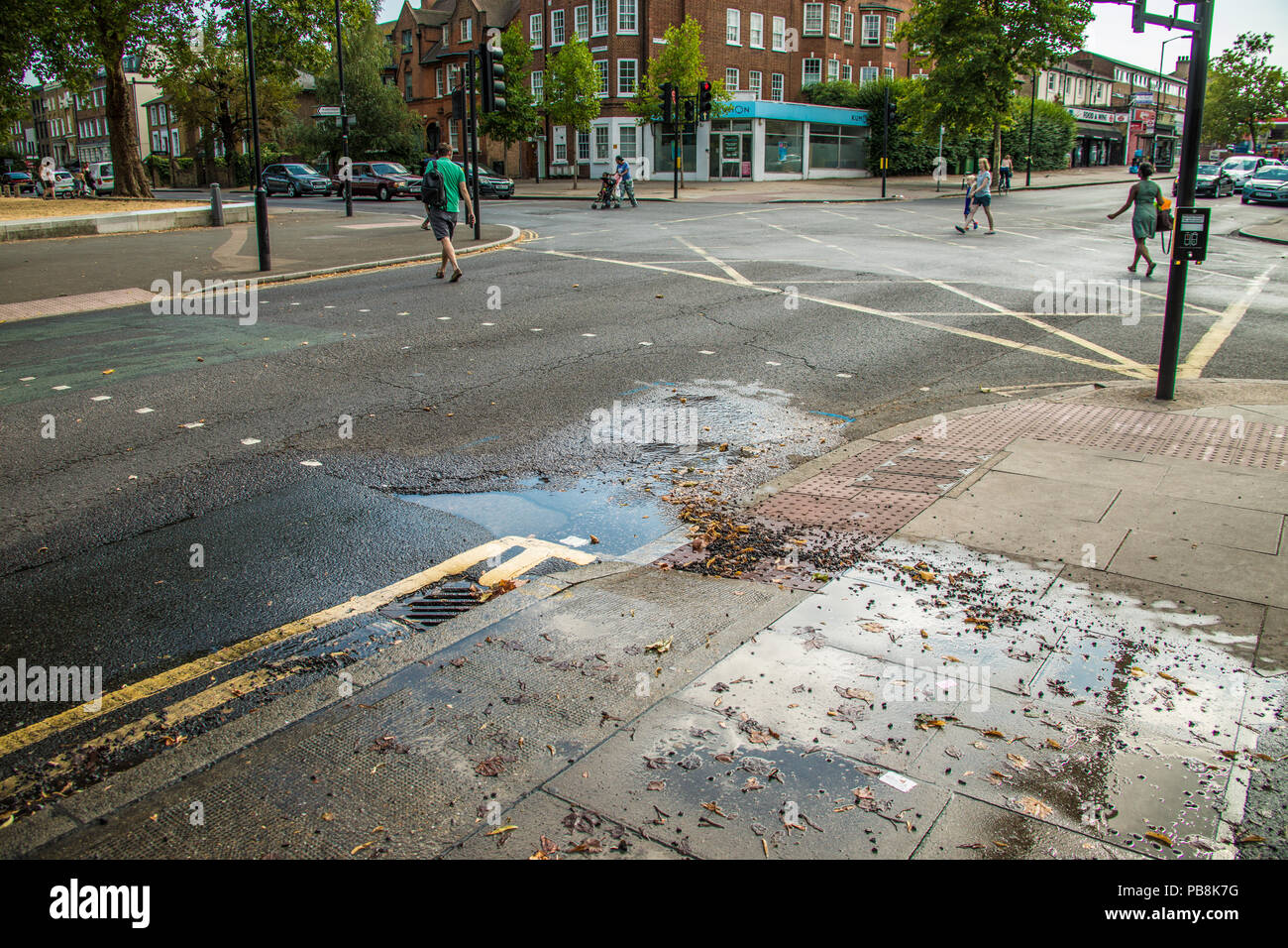 London,UK. 26 July,2018. A pothole caused by a wate leak with the top ...