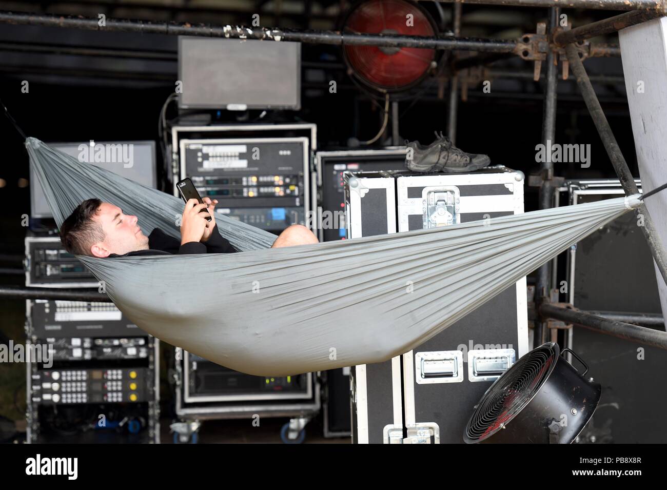 Lulworth Castle, Dorset, UK. 27th July 2018. Technician takes a break Credit: Finnbarr Webster ...