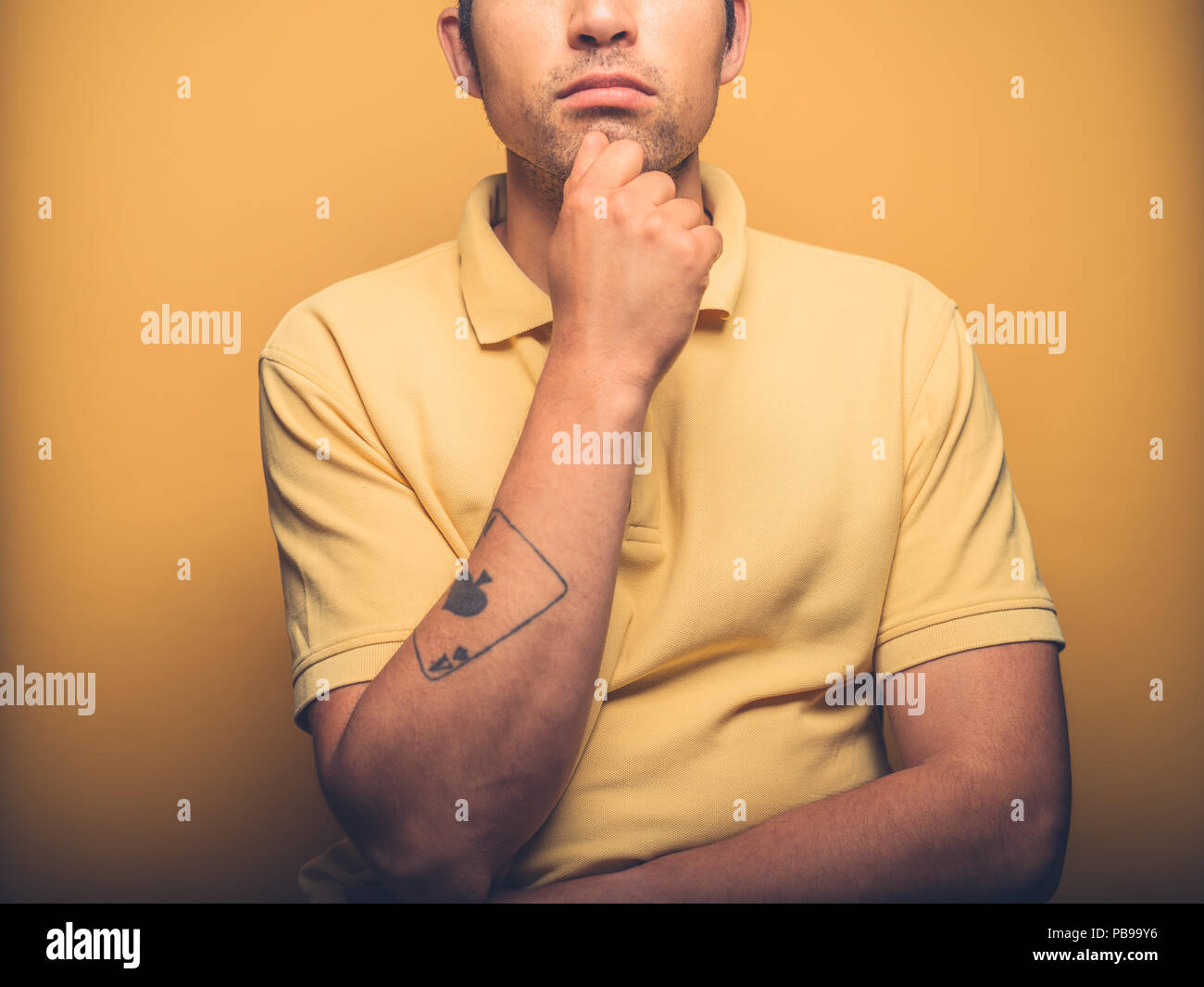 A thoughtful man is scratching his chin Stock Photo - Alamy