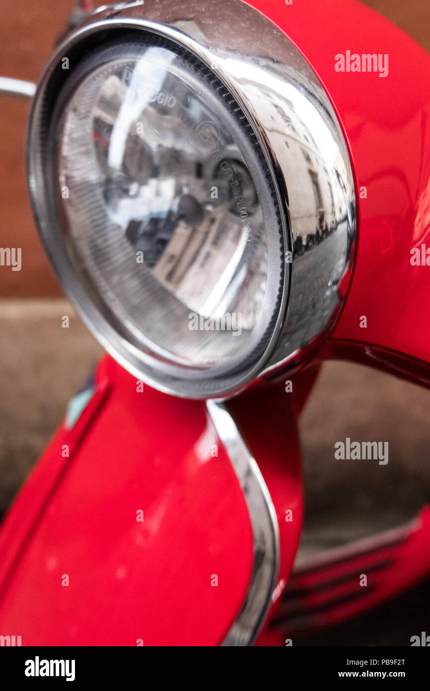 Red Vespa scooter front light Stock Photo - Alamy