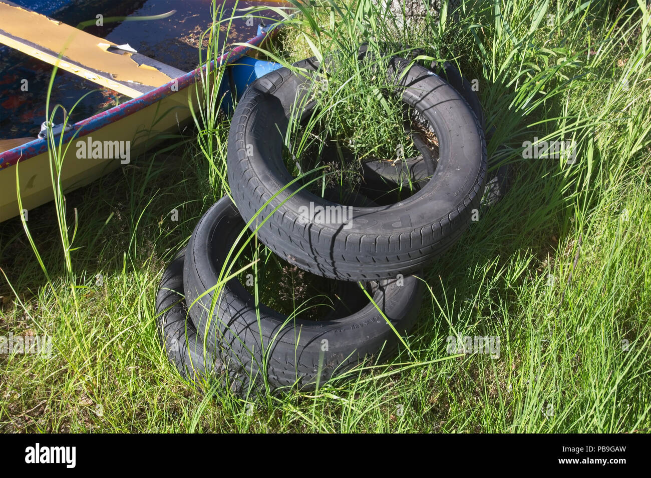 car tyres in grass at harbour, Finland Stock Photo - Alamy
