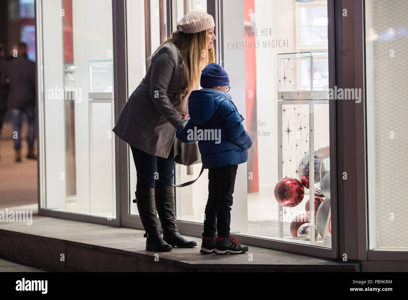 Boy looking at shop window hi-res stock photography and images - Alamy