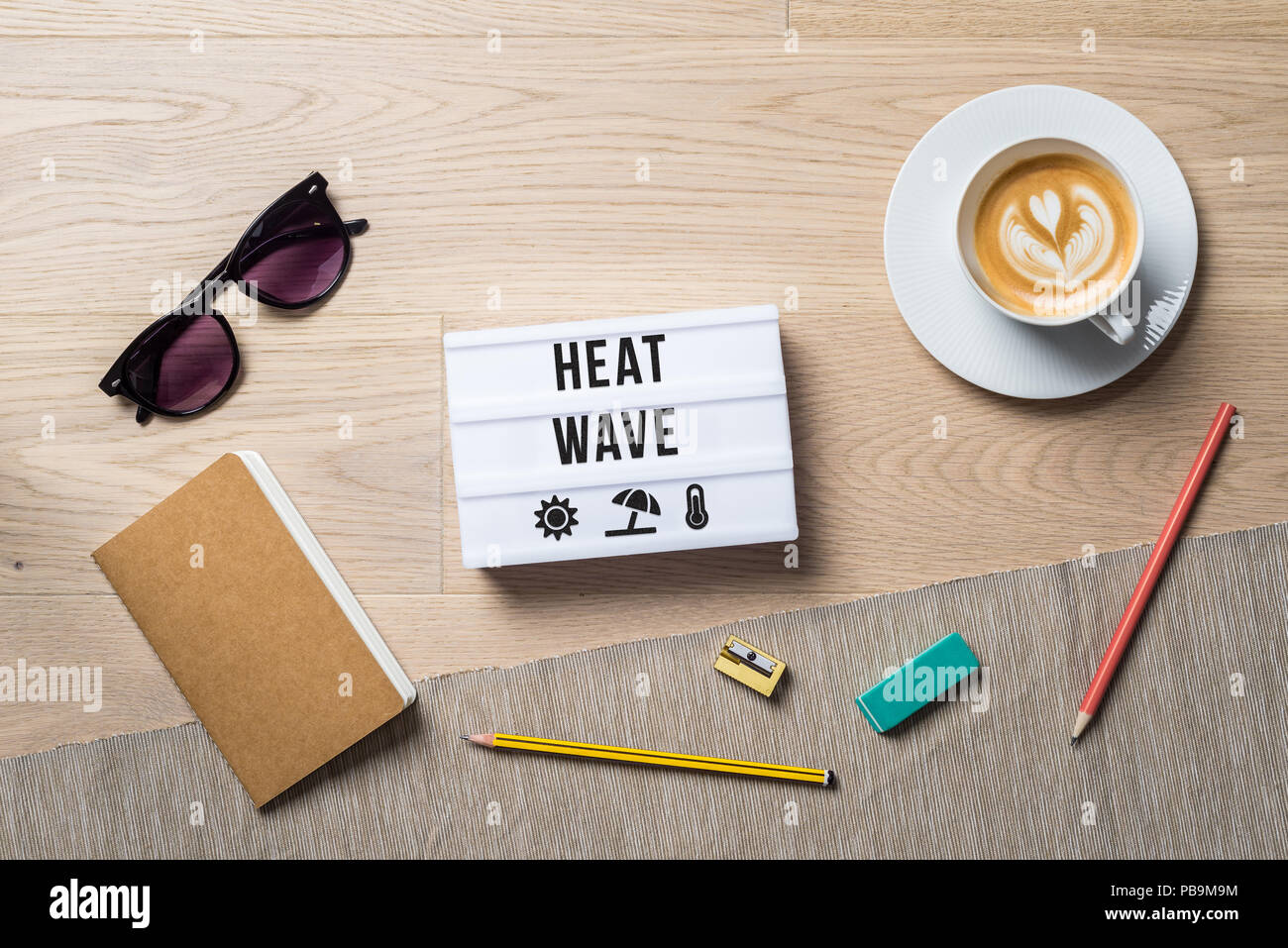 Heat wave written on light box with sun and thermometer icons as ...