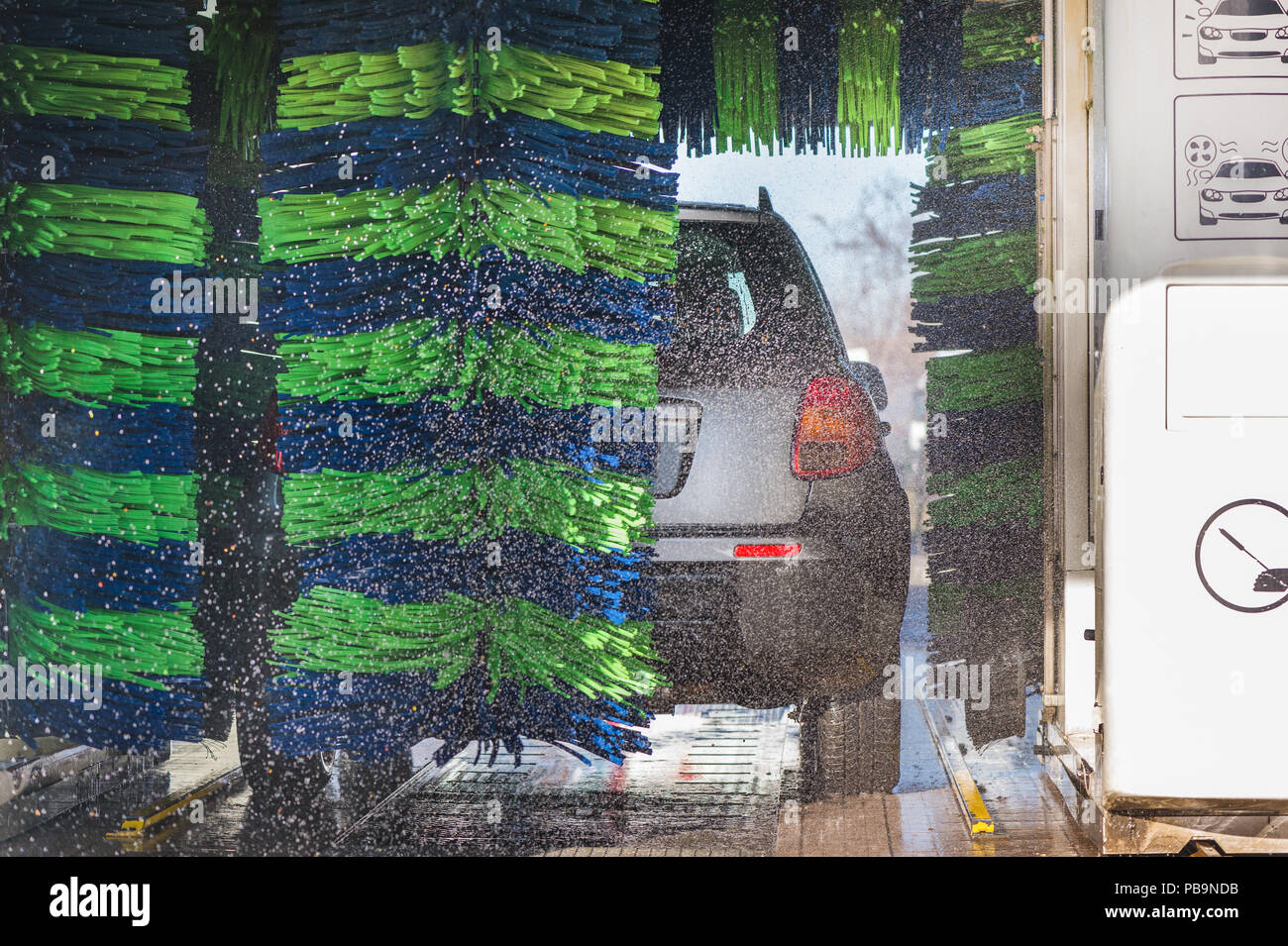 Grey car during washing process Stock Photo - Alamy