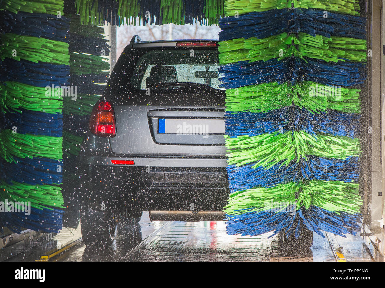 Grey car during washing process Stock Photo - Alamy