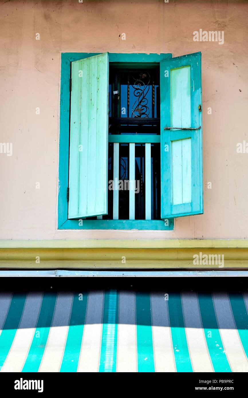 Perspective view of vintage window with open green antique wooden ...