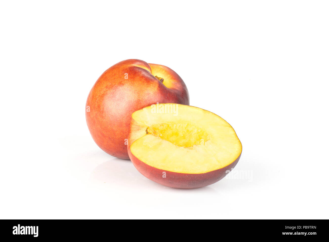 Group of one whole one half of ripe deep red nectarine isolated on ...