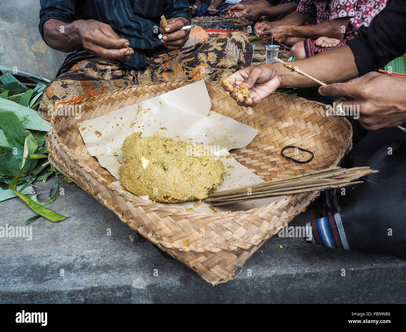 Two men making traditional Balinese satay in a local temple in Ubud for ...
