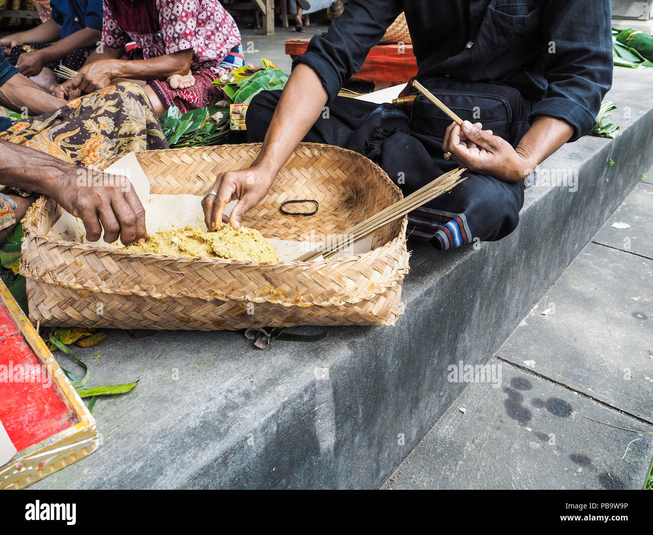 Two men making traditional Balinese satay in a local temple in Ubud for ...