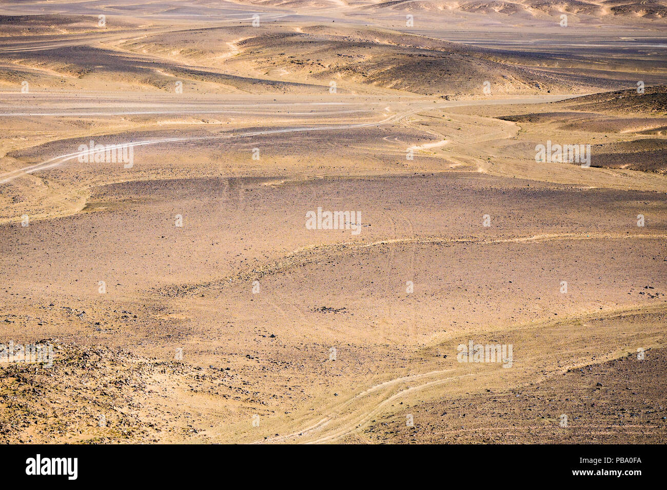 Volcanic black basalt terrain in Sahara desert in Morocco Stock Photo ...