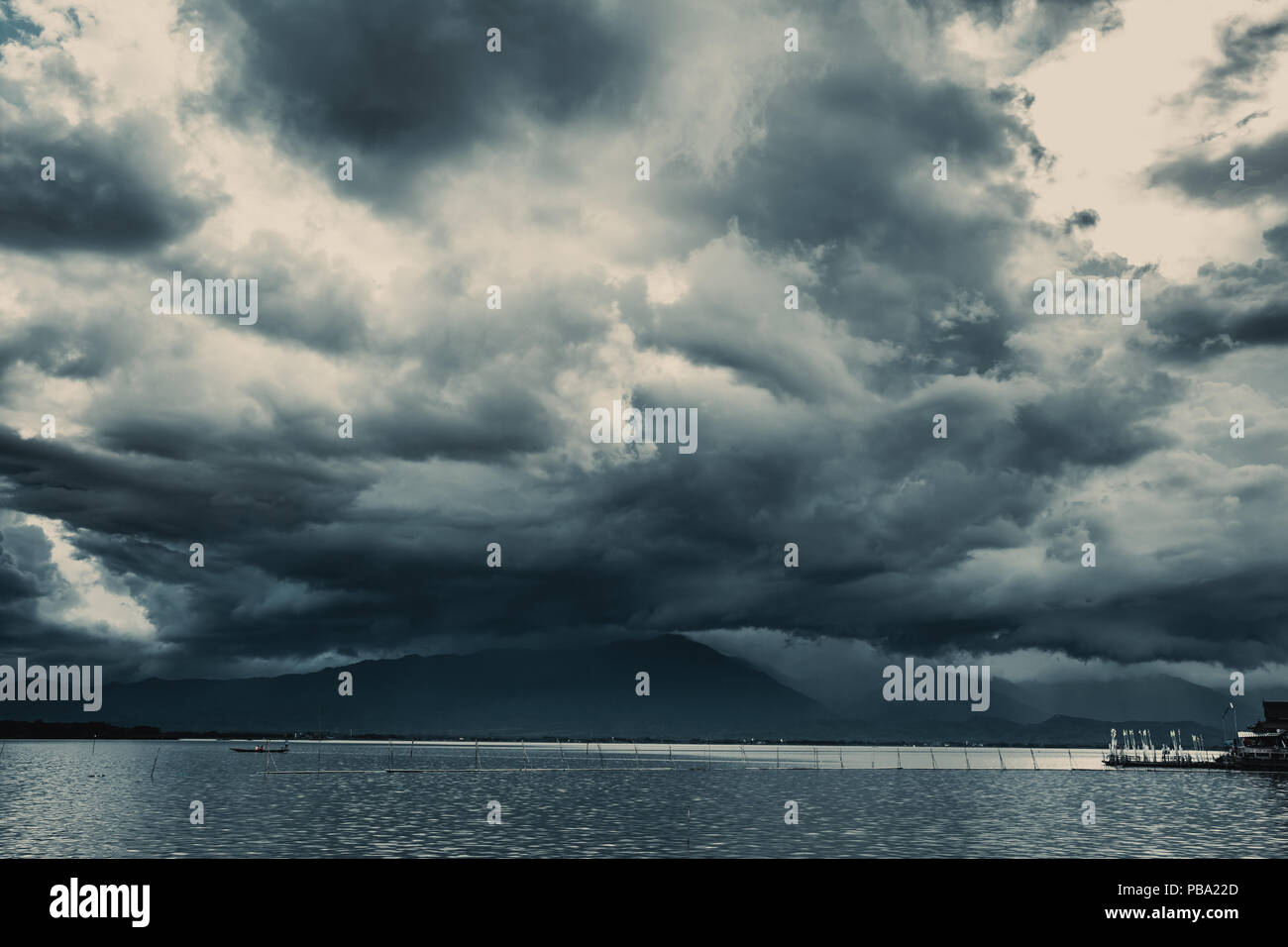 Storm cloudy sky raining over the mountain with lake river view nature ...