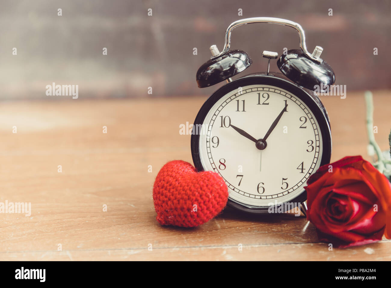 love clock red heart and rose flower romantic time on wooden table ...