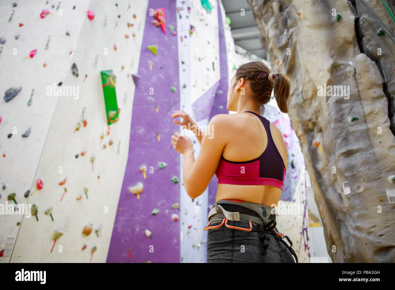 Photo from back of young girl athlete on background of wall for rock ...