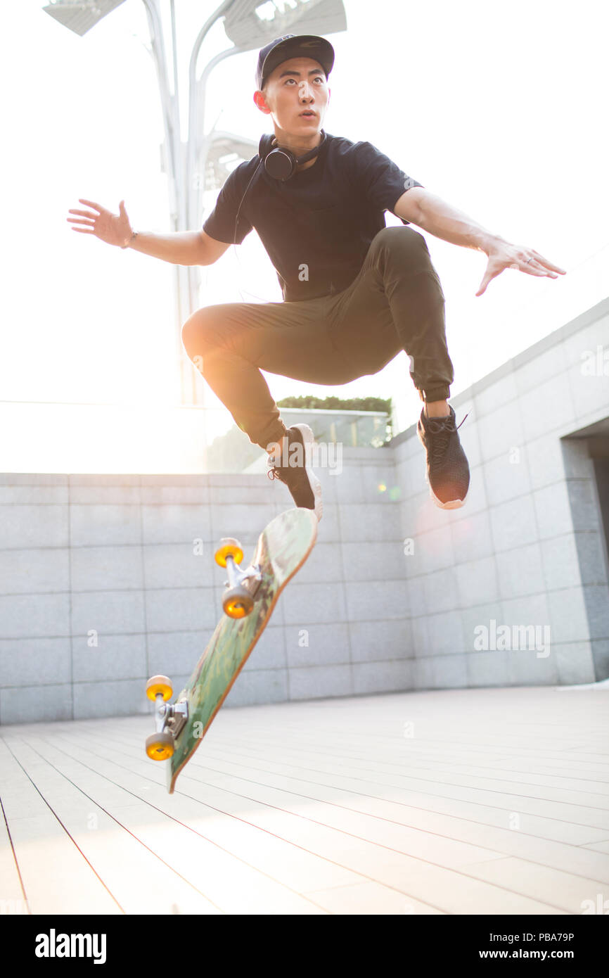 Young Chinese man skateboarding Stock Photo - Alamy