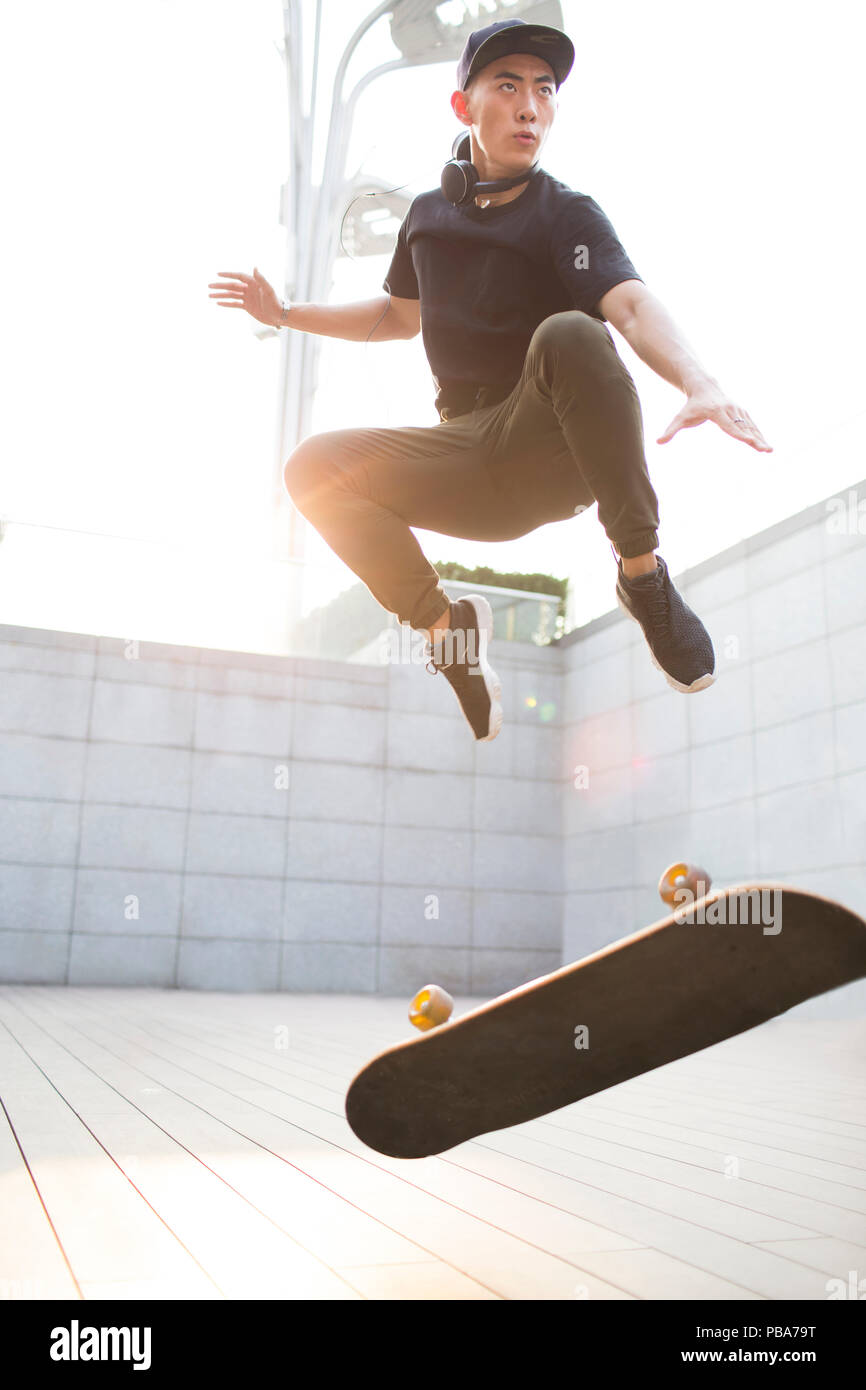 Young Chinese man skateboarding Stock Photo - Alamy
