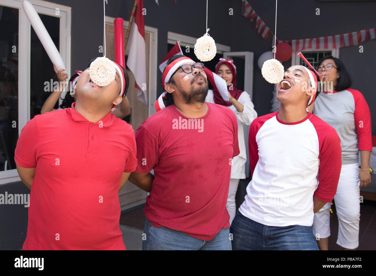 indonesia crackers eating competition Stock Photo - Alamy