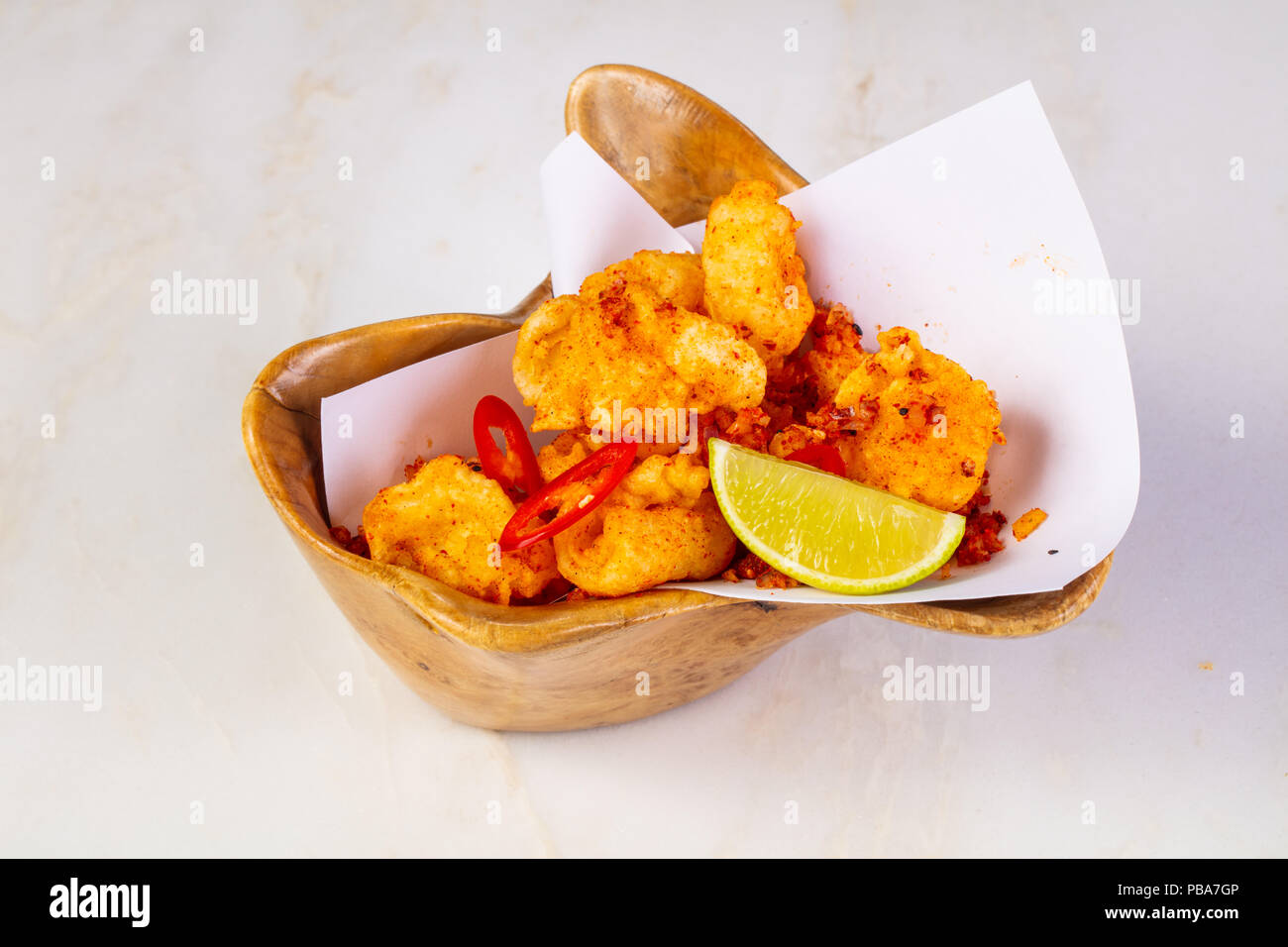 Crispy squid with chili and lemon Stock Photo - Alamy