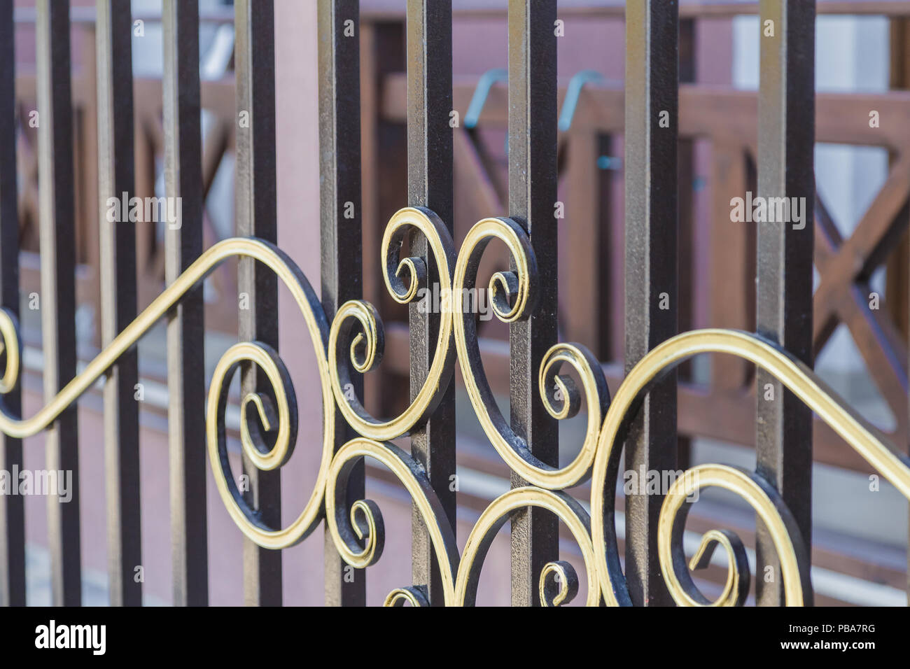 Antique forging on the iron gate with gold paint Stock Photo - Alamy