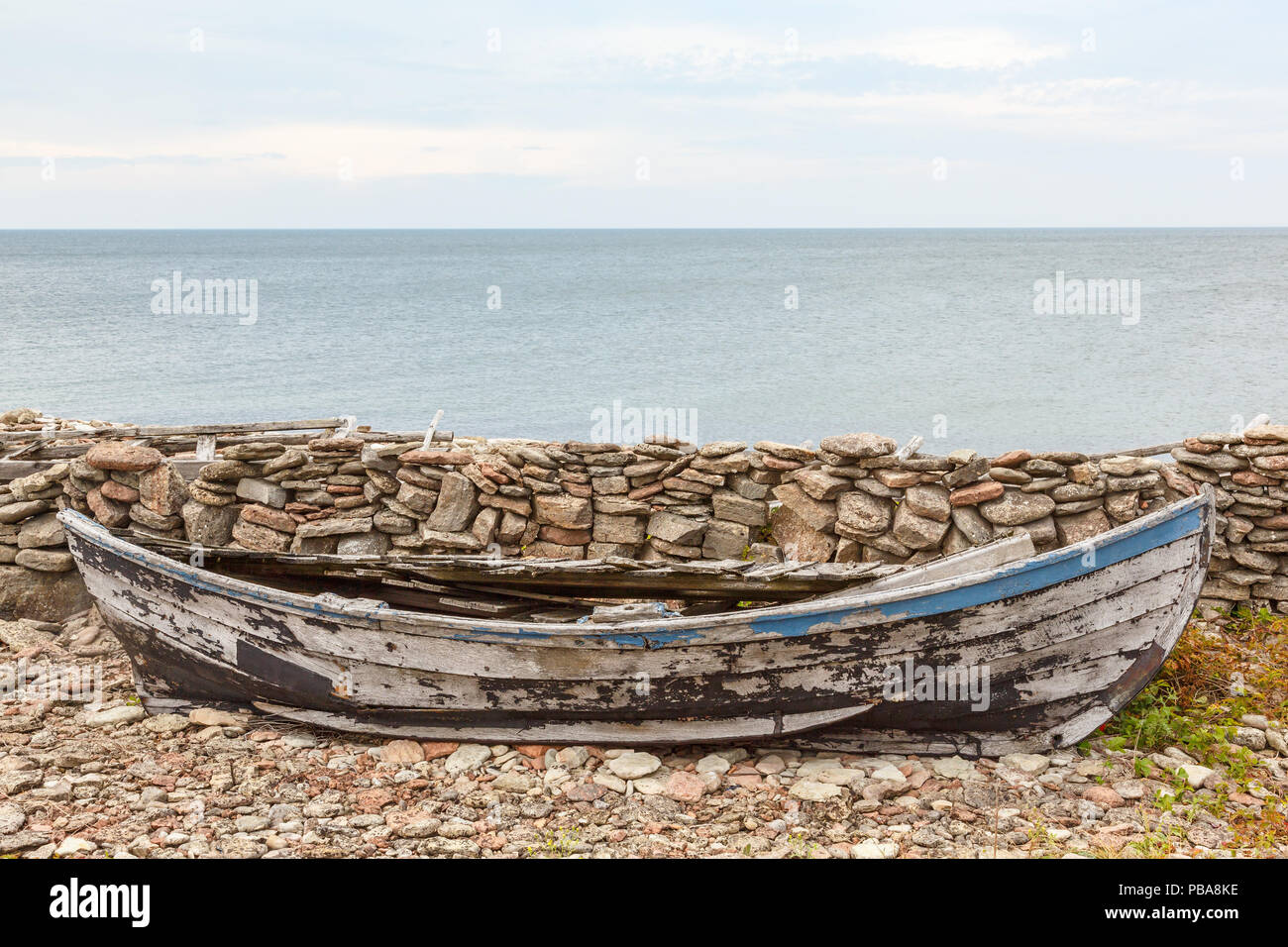 Old rotten rowboat at the beach with the sea in the background Stock ...