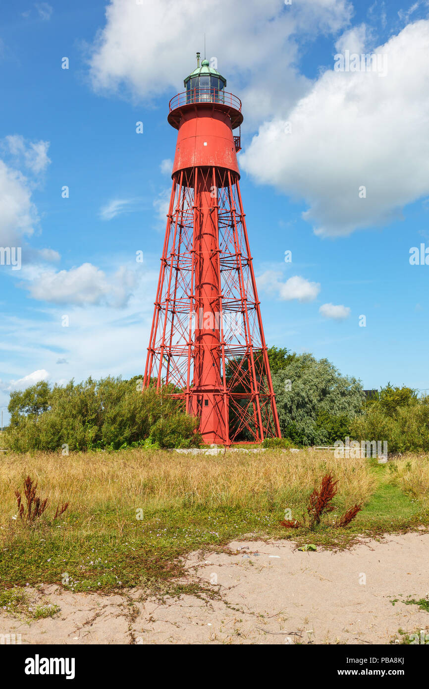 Red cast iron lighthouse on the beach Stock Photo - Alamy