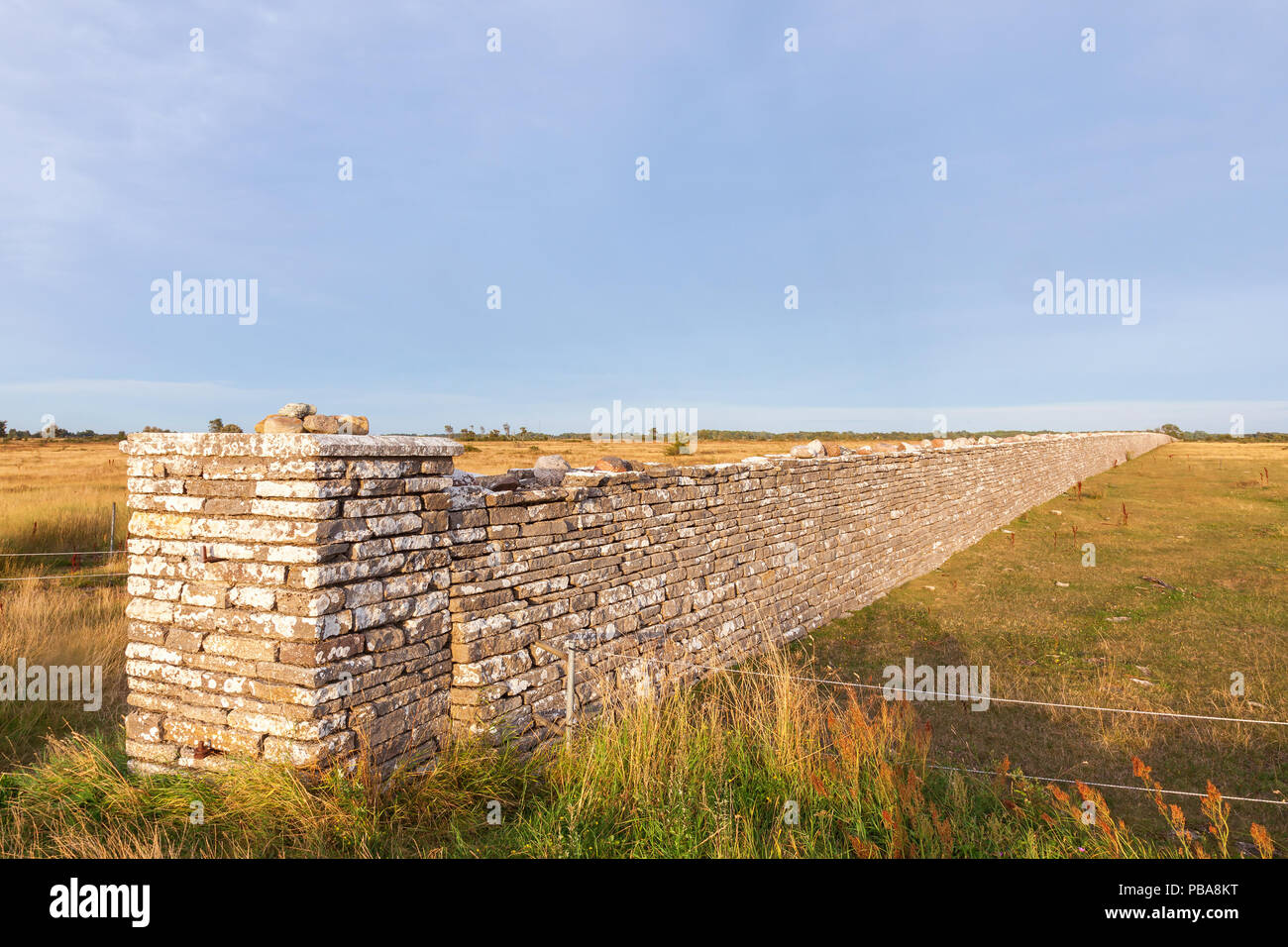 High stone wall in the landscape Stock Photo - Alamy
