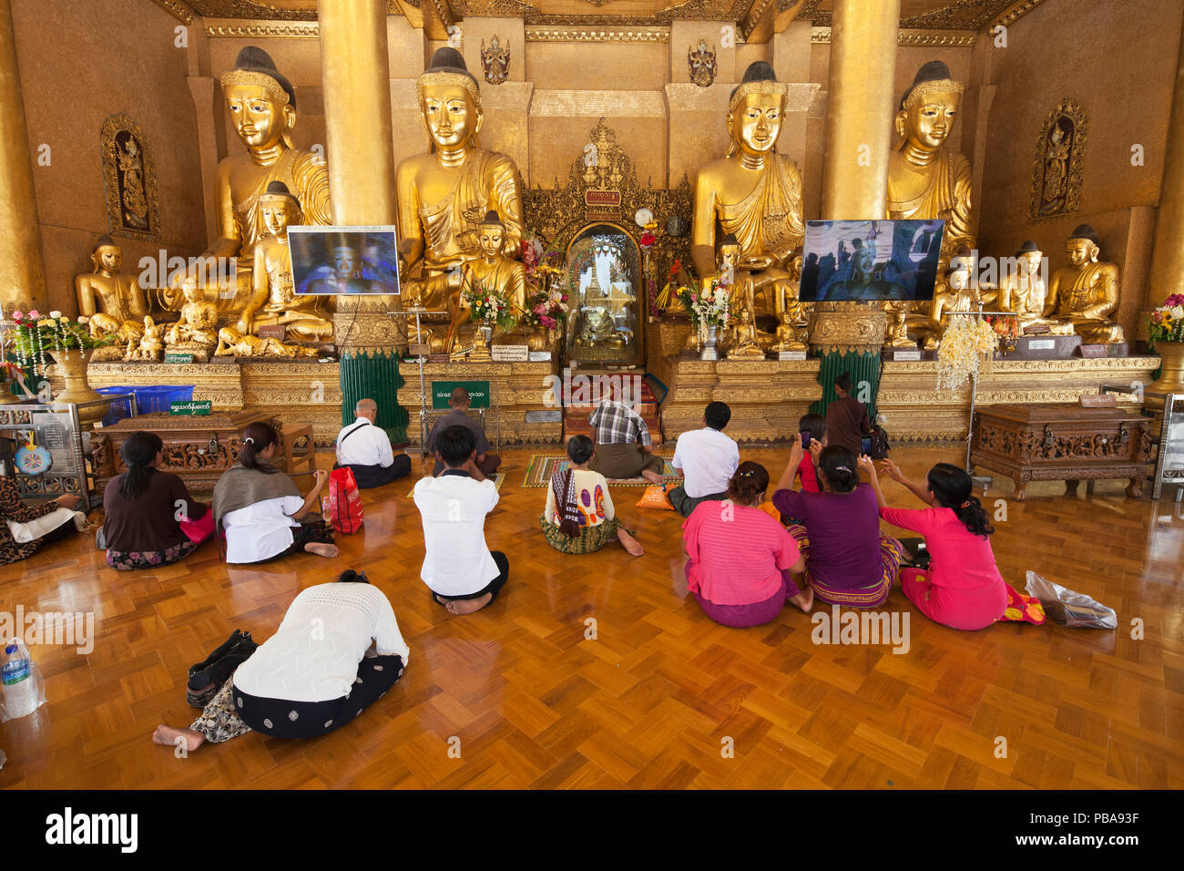 Devotees prying in the Temple with the Padamya Myetshin image of the ...