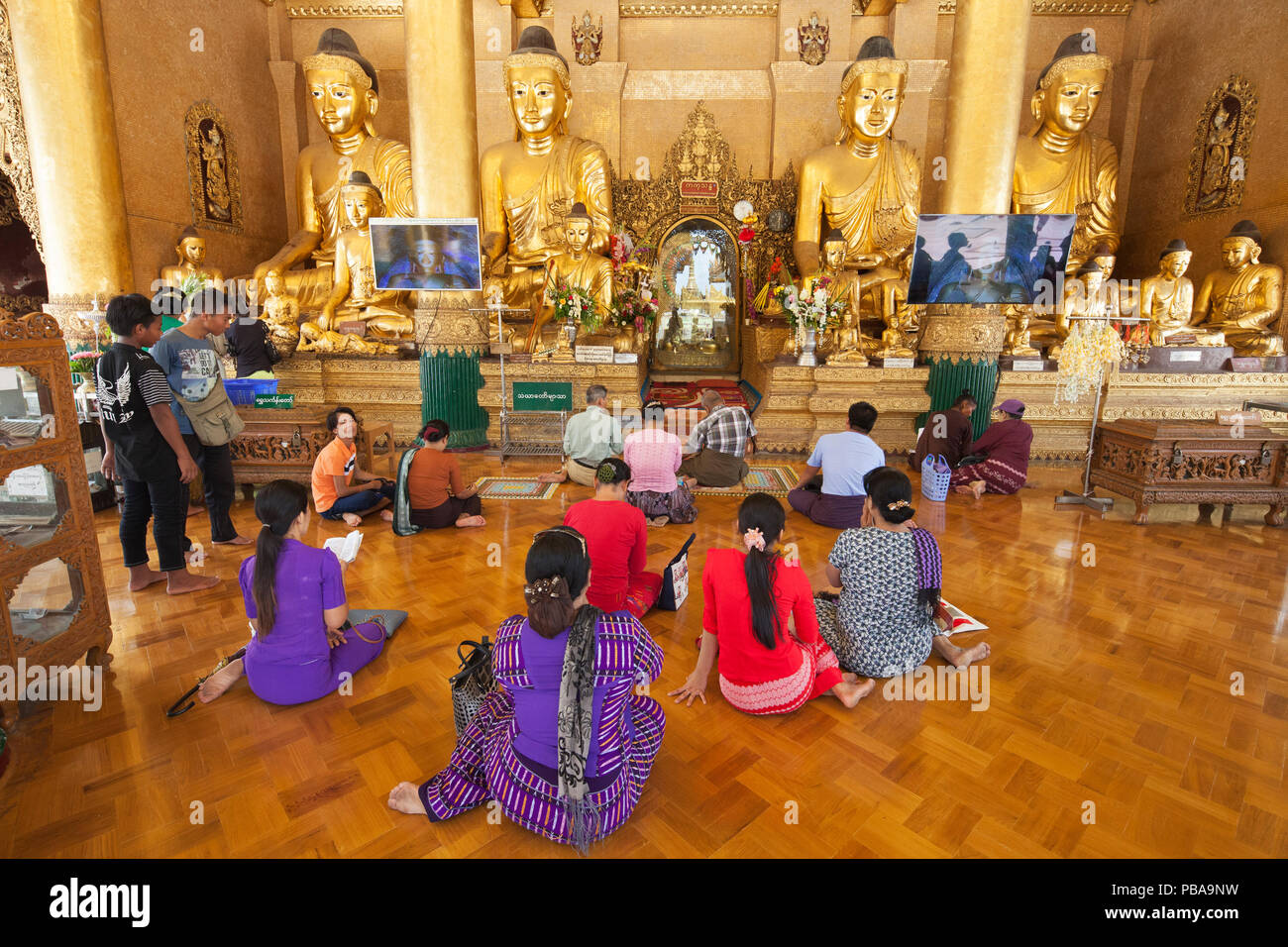 Devotees prying in the Temple with the Padamya Myetshin Buddah image ...