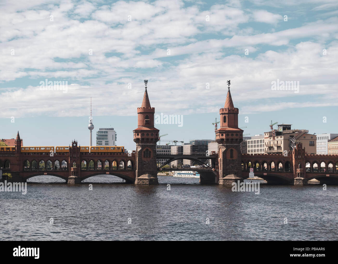 old red bridge with two towers, Oberbaum bridge, over Spree river in ...