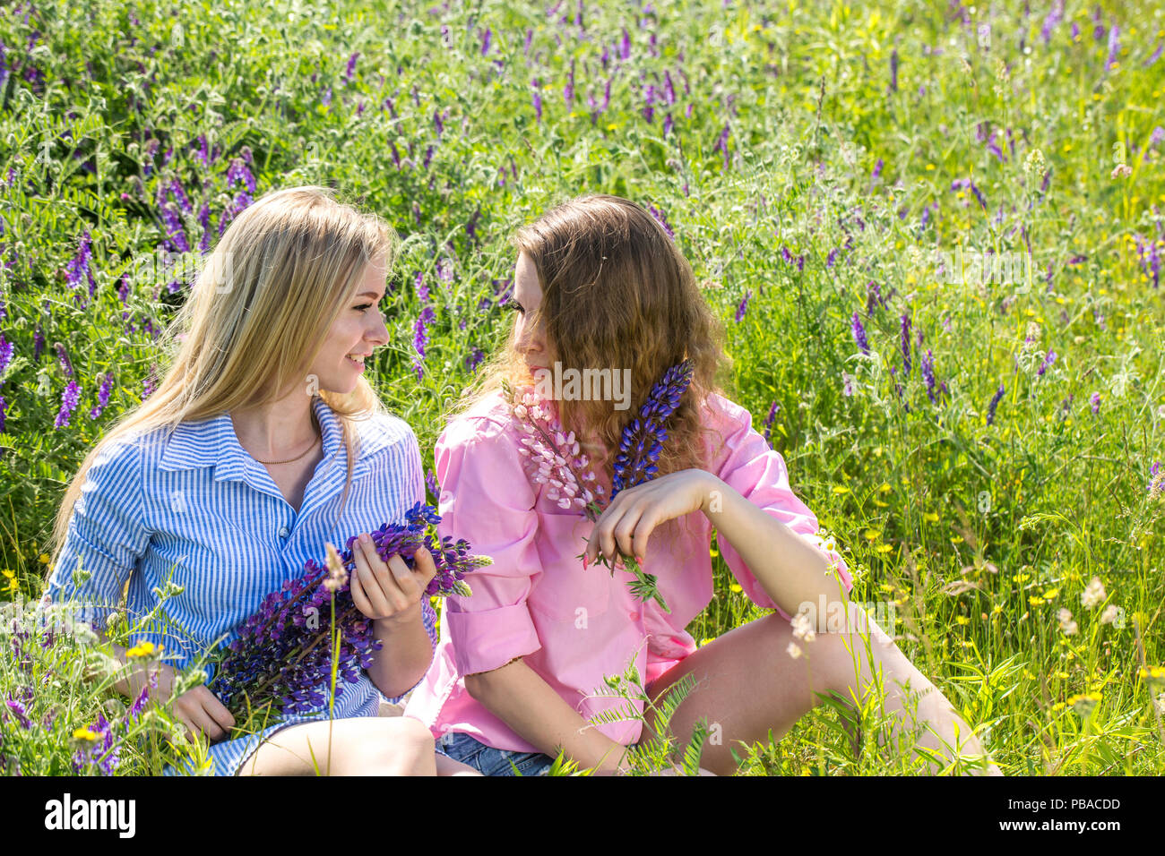 Two friends communicate in nature Stock Photo - Alamy