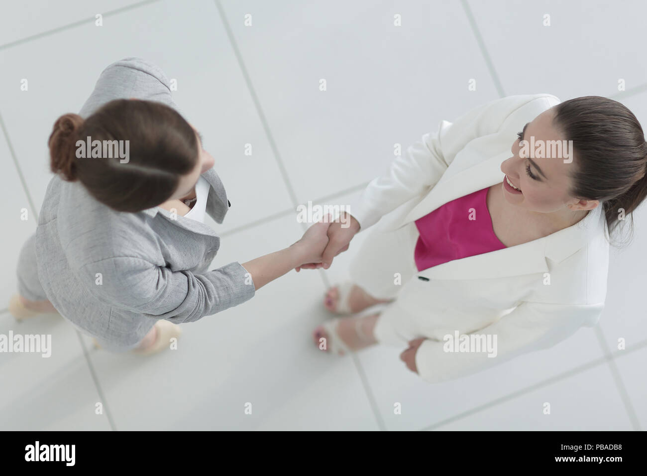 view from the top. handshake elegant business women Stock Photo - Alamy