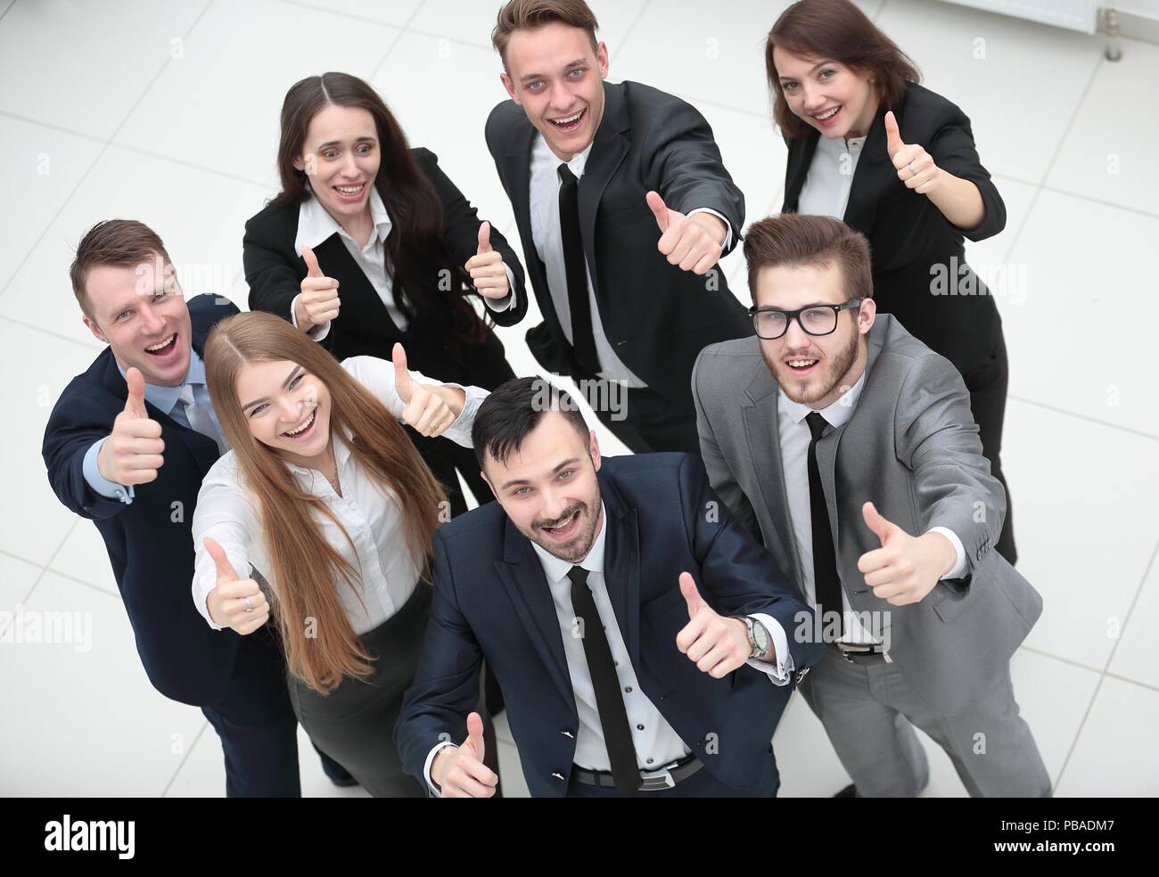 successful business team holding up a thumbs up Stock Photo - Alamy